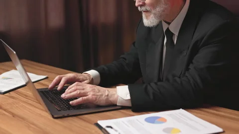 Older person typing on laptop at writing... | Stock Video | Pond5