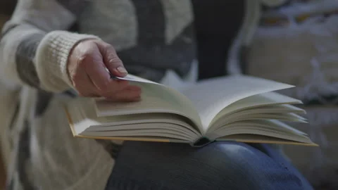 Older Woman Flips Pages Of Book | Stock Video | Pond5