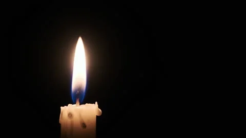 One Candle is Lit on a Black Background | Stock Video | Pond5