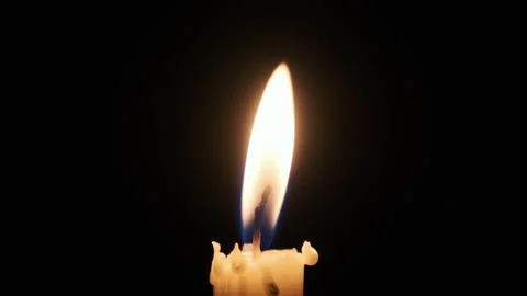 One Candle is Lit on a Black Background | Stock Video | Pond5