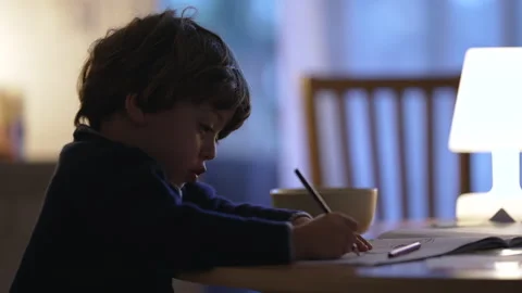 One concentrated child drawing on paper.... | Stock Video | Pond5