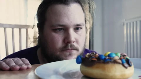 One fat man in front of donut snack on p... | Stock Video | Pond5