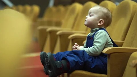 One little boy in a theater auditorium | Stock Video | Pond5