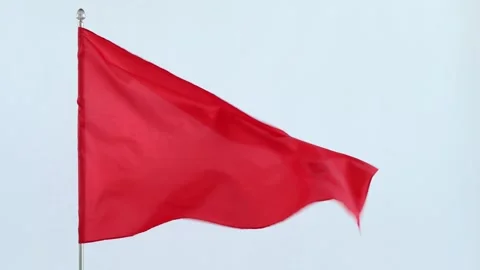One red flag fluttering on white backgro... | Stock Video | Pond5