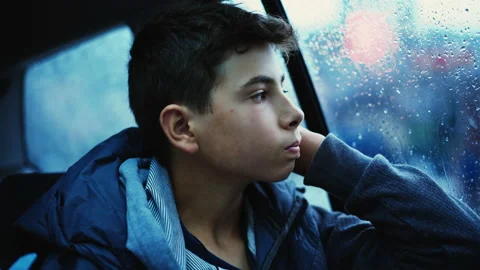 One sad teen boy inside car looking outs... | Stock Video | Pond5