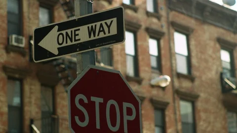 One way sign board and stop sign in stre... | Stock Video | Pond5