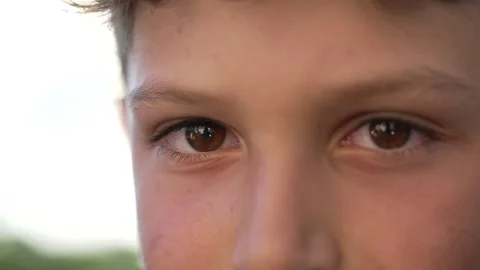 One young boy close up eyes looking at c... | Stock Video | Pond5