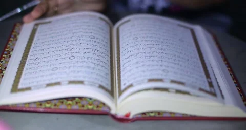 Open and search for surah al quran. Youn... | Stock Video | Pond5