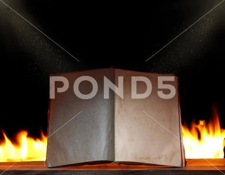 Photograph: Open book in ambient light with fire on background #134024237