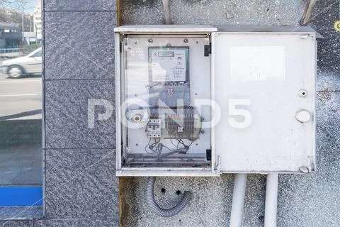 Open distribution switchboard with electric meter box on a outdoor wall ...