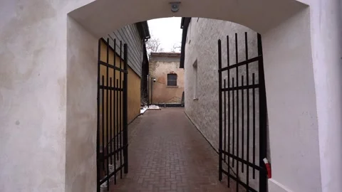 an open metal gate leading into a narrow... | Stock Video | Pond5