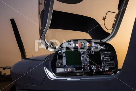 Open small private cockpit jet in sunset control panel ~ Hi Res #150322448