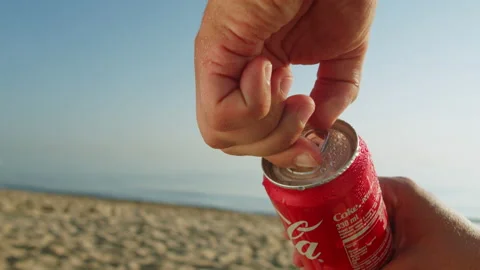 Opening a can of Coca Cola on the seasho... | Stock Video | Pond5