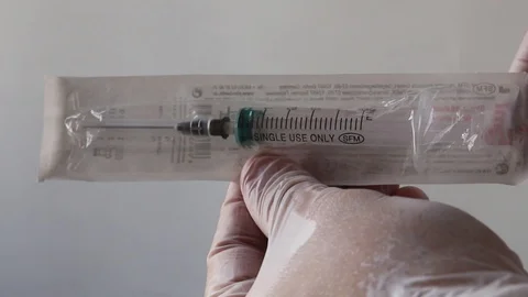 Opening the syringe packaging | Stock Video | Pond5