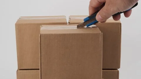 Opens the box with a utility knife. | Stock Video | Pond5