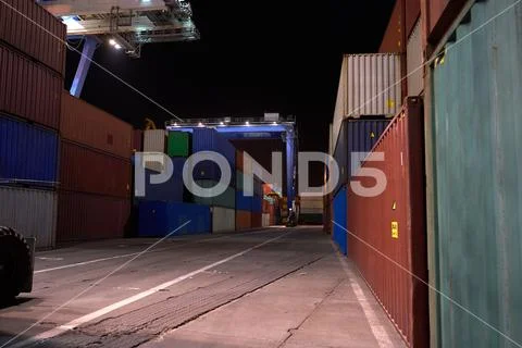 Operation of container terminal at night. Unloading container ship at ...