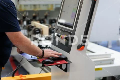 Operator works at control panel of CAD CAM machine Stock Photo #285712215