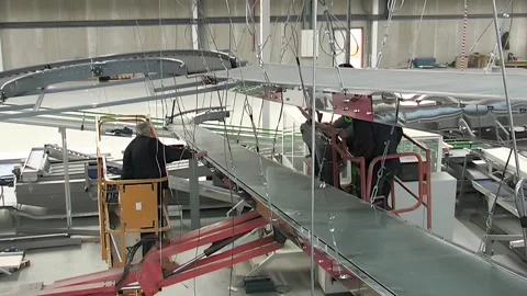 Operators installing a industrial line o... | Stock Video | Pond5