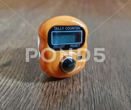 An orange counter on wooden background ~ Premium Photo #212211509