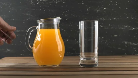 Orange juice being poured in tall glass.... | Stock Video | Pond5