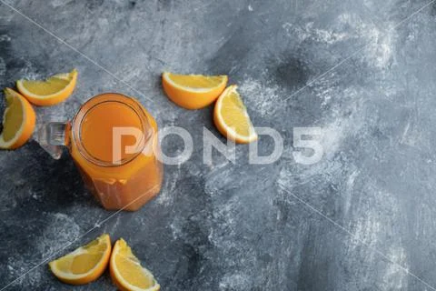 Orange juice in a glass pitcher with sliced orange fruit Stock Photo #149218975