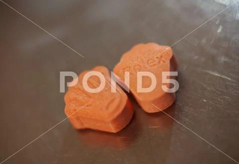 Orange pills with mdma ecstasy dope rolex drug close up background fine ...
