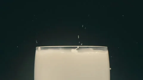 Oreo cookie falling into glass of milk a... | Stock Video | Pond5