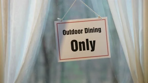 Outdoor Dining Only sign swinging in the... | Stock Video | Pond5