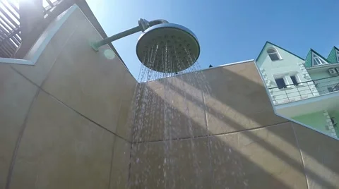 Outdoor poolside shower falling water at... | Stock Video | Pond5