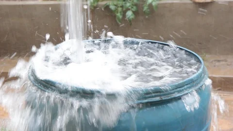 An overflowing water tank below a spout ... | Stock Video | Pond5