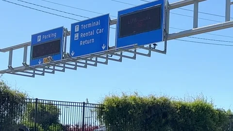 Overhead airport terminal parking signs | Stock Video | Pond5