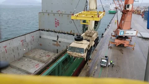 Overhead crane lifting military truck in... | Stock Video | Pond5