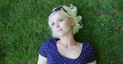 Overhead shot of female sunbathing in pa... | Stock Video | Pond5