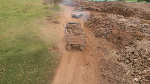 Overhead shot following the dump trucks ... | Stock Video | Pond5