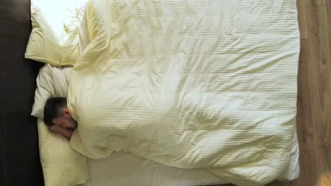 overhead top view of man sleeping in bed | Stock Video | Pond5