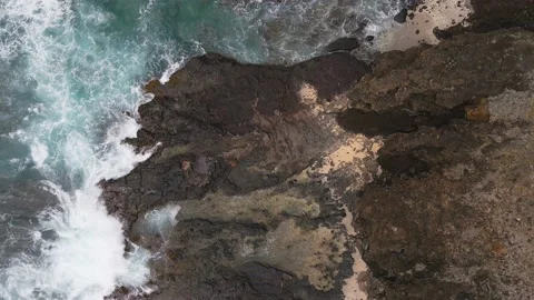 Overhead view of waves on rocky beach cl... | Stock Video | Pond5