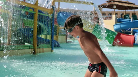 Overjoyed male kid splashing water aqua ... | Stock Video | Pond5