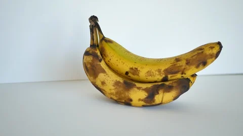 Overly ripe bananas isolated on white ba... | Stock Video | Pond5