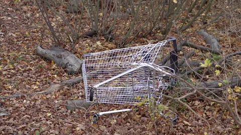An overturned shopping cart lies in the ... | Stock Video | Pond5