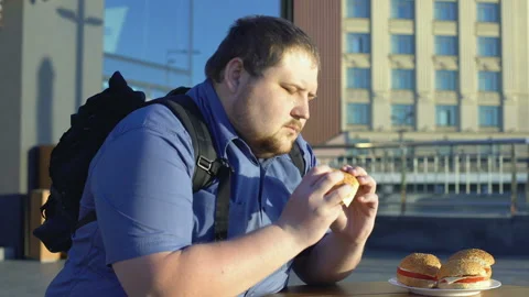 Overweight male chewing burger, unhealth... | Stock Video | Pond5