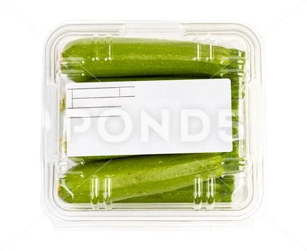 Photograph: Packed and labeled green zucchini isolated on white ...