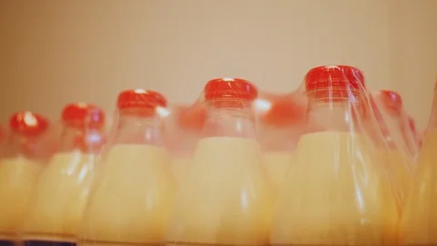 packs of milk bottles with red caps on l... | Stock Video | Pond5