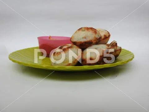 Paddu or Kuzhi paniyaram and Coconut Chutney in a Green Plate isolated ...