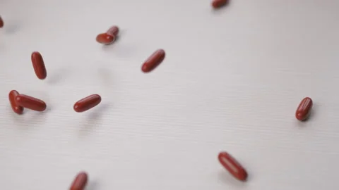 Pain-relieving red pills fall on the tab... | Stock Video | Pond5