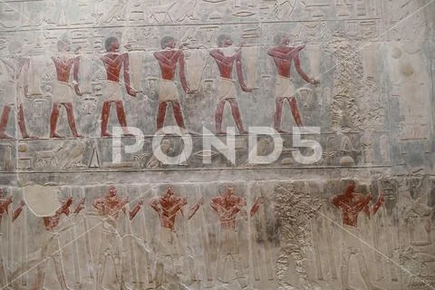 Painted bas relief figures showing daily life in ancient Egypt Stock ...