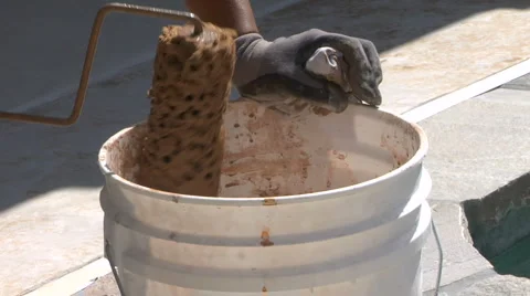 Painter wipes off excess paint from spon... | Stock Video | Pond5