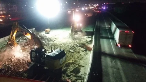Pair of excavators working at night on r... | Stock Video | Pond5
