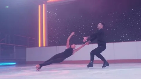 Pair of figure skaters rotating on ice r... | Stock Video | Pond5