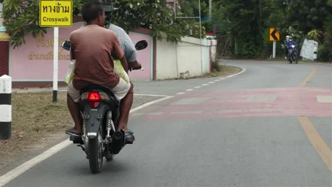 A pair of men ride a motorcycle | Stock Video | Pond5