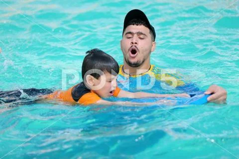 Palestinian children swim in a pool during a swimming lesson in Gaza ...